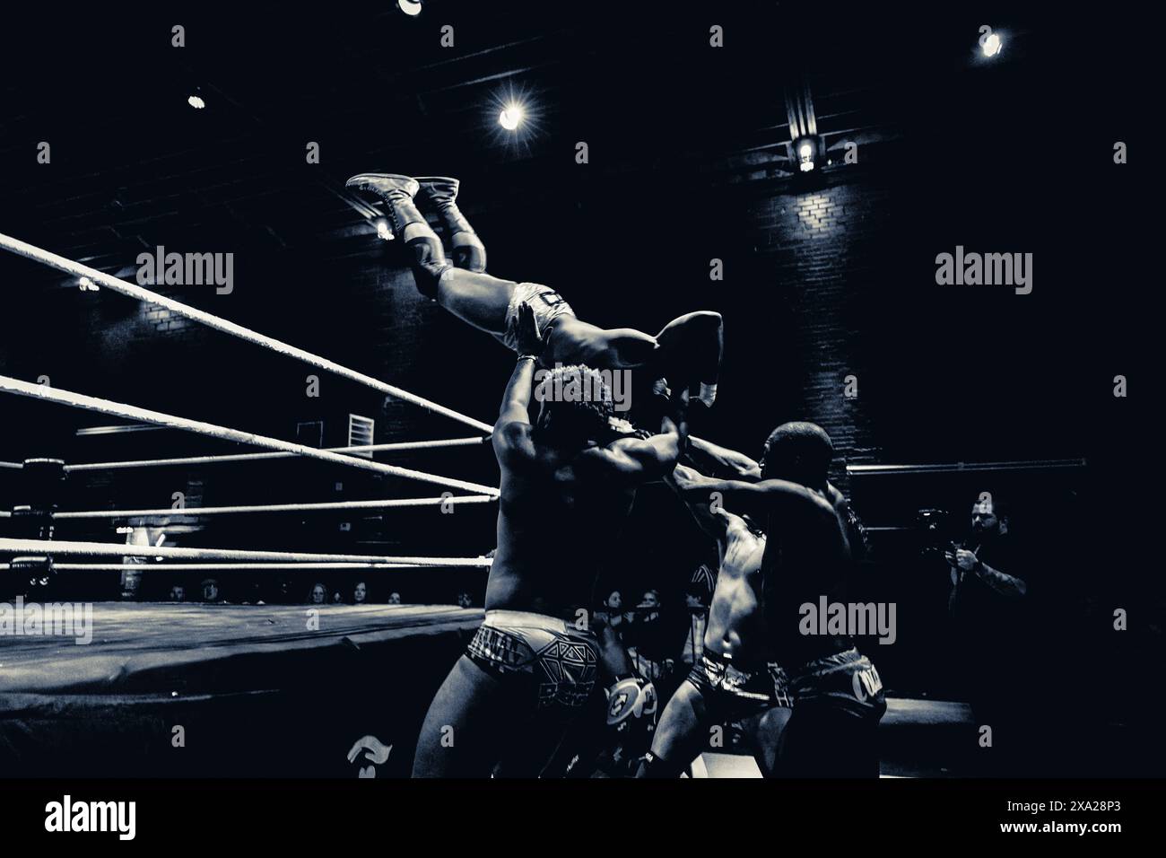 Two boxers in a fierce match, one raising the fists of the other Stock ...