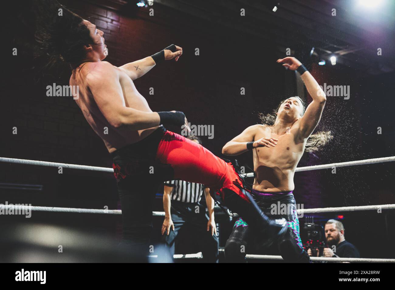 Two wrestlers in red trunks grapple in the ring Stock Photo - Alamy