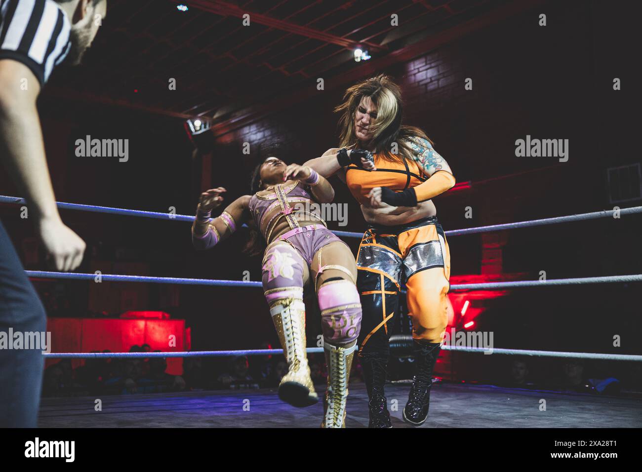 Two female wrestlers in fighting attire engaged in a match Stock Photo ...