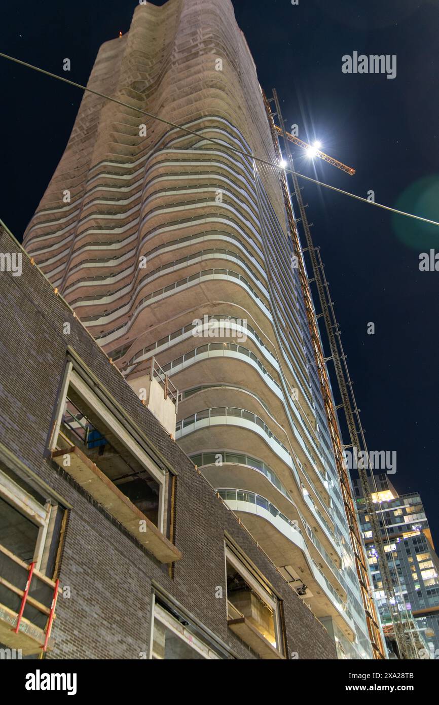 Skyscraper under construction cityscape at night Stock Photo - Alamy