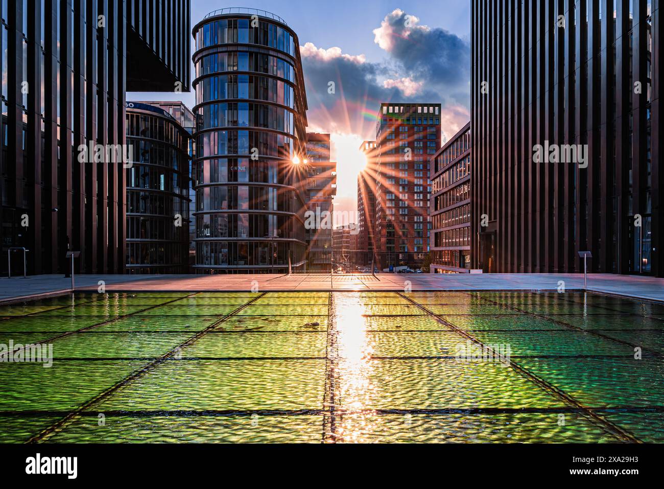 Sunlight filters through tall city buildings Stock Photo - Alamy