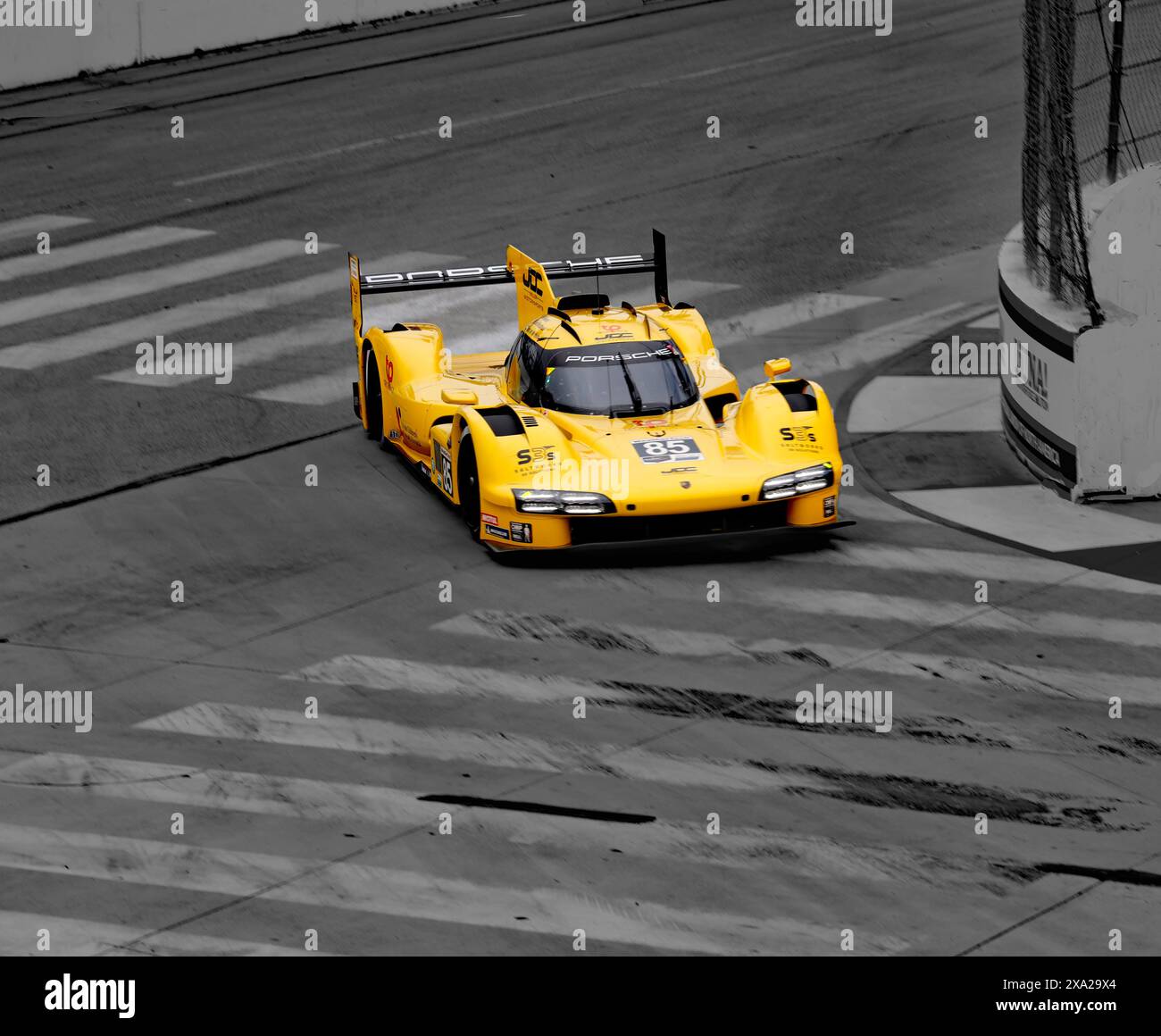 Yellow race car at black and white street crossing Stock Photo - Alamy