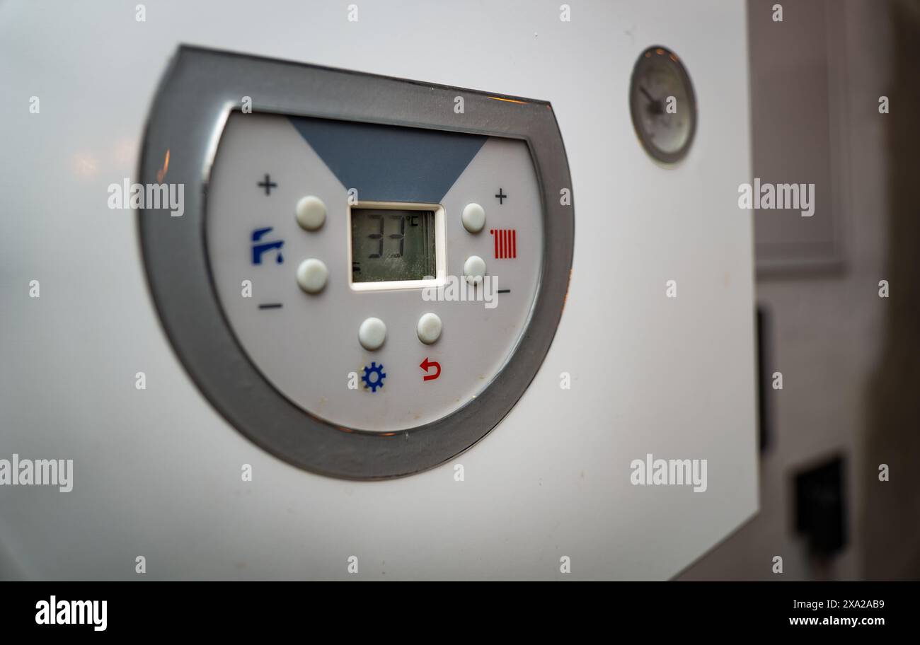 A close-up shot of a boiler control panel displaying a temperature of ...