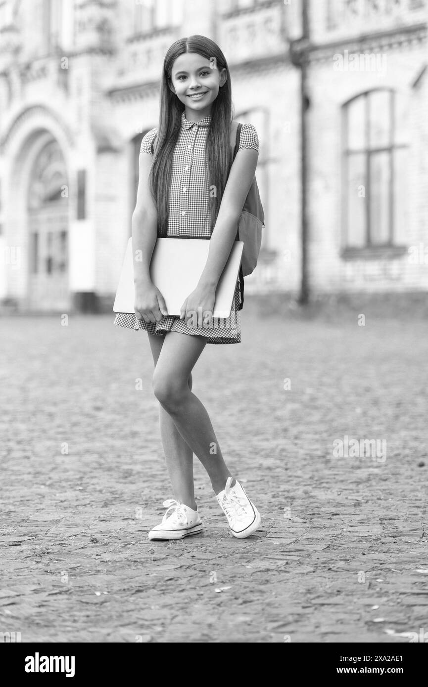 cheerful school girl stydy online outdoor. photo of school girl stydy ...