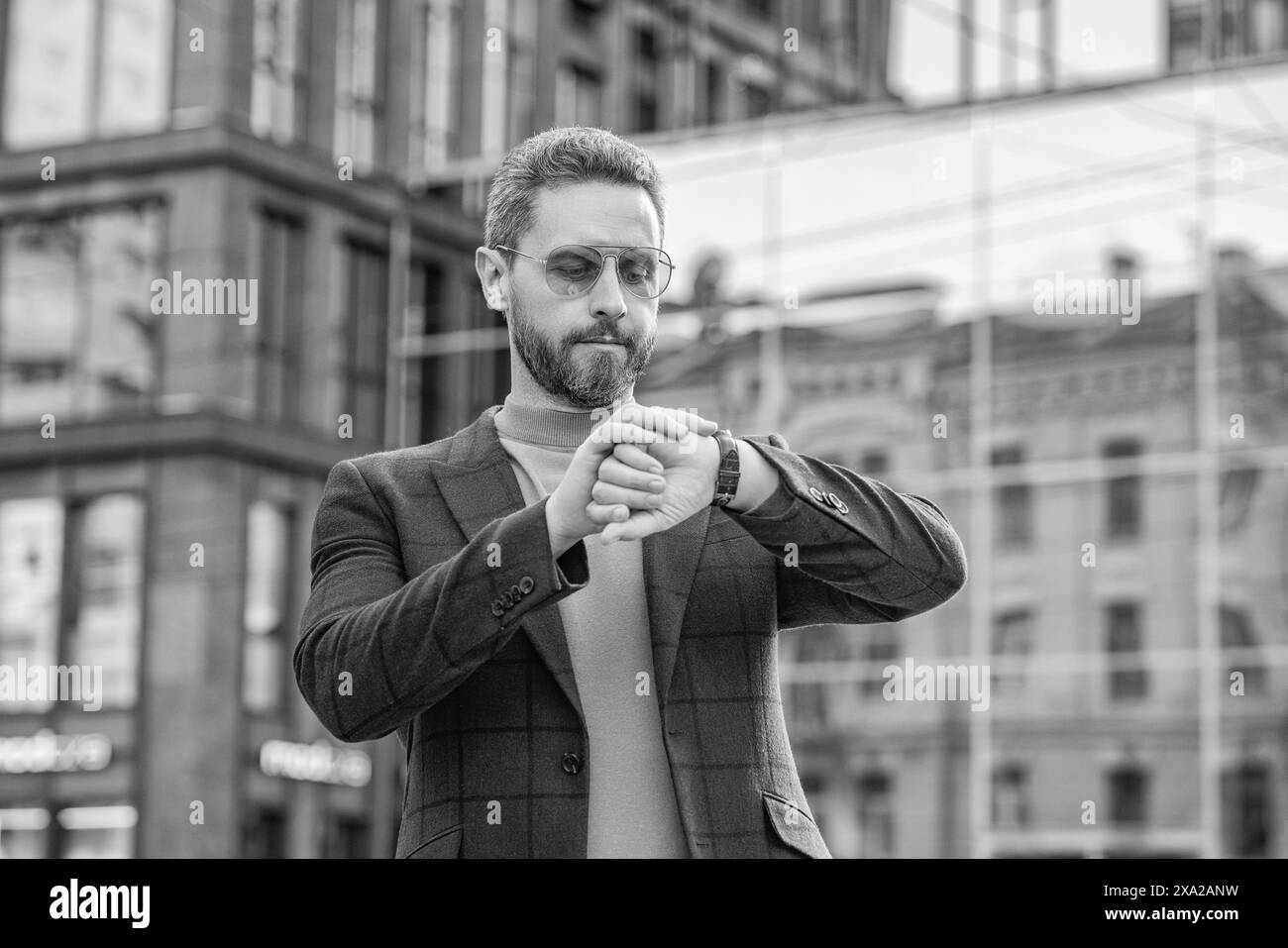 punctual man in jacket and glasses check time outdoor. punctual man ...