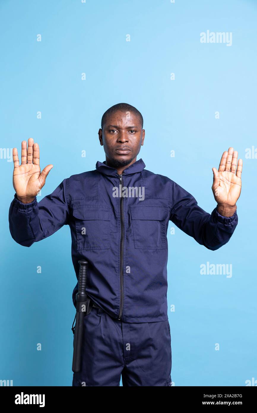 Male security officer putting his hands up as a stop sign on camera ...