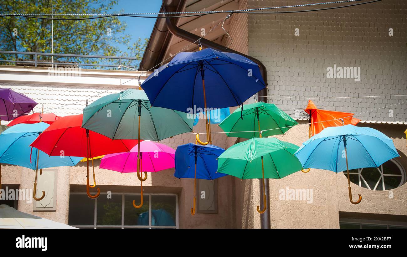 Colorful umbrellas suspended above hi-res stock photography and images ...