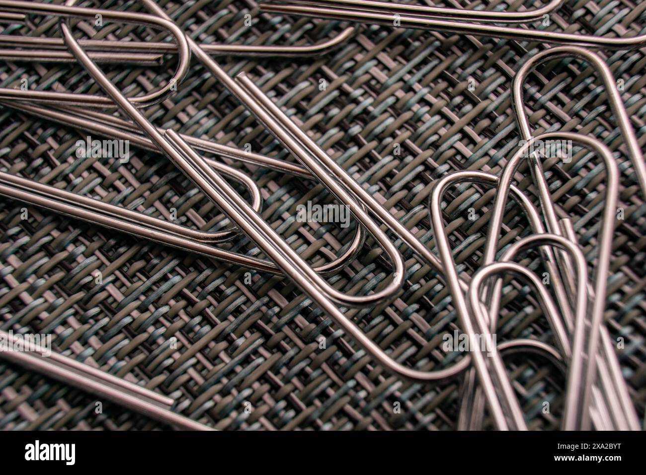 Silver Paper Clips on a Woven Surface Stock Photo - Alamy