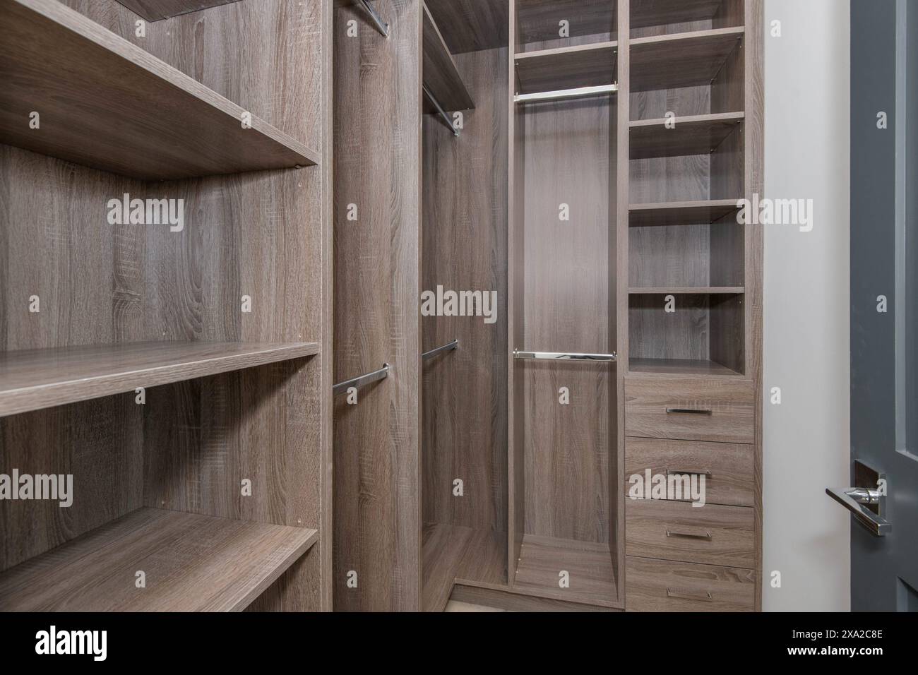 A neat walk-in closet with open shelving in a modern new construction home in Los Angeles Stock ...