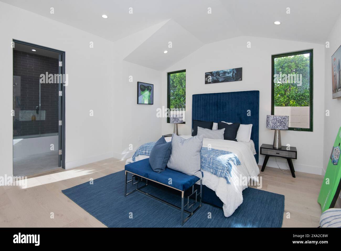 A neat, tidy room set up for rest in a modern new construction home in ...