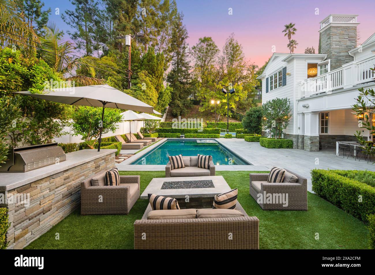 A poolside patio with outdoor dining table in a new construction home ...