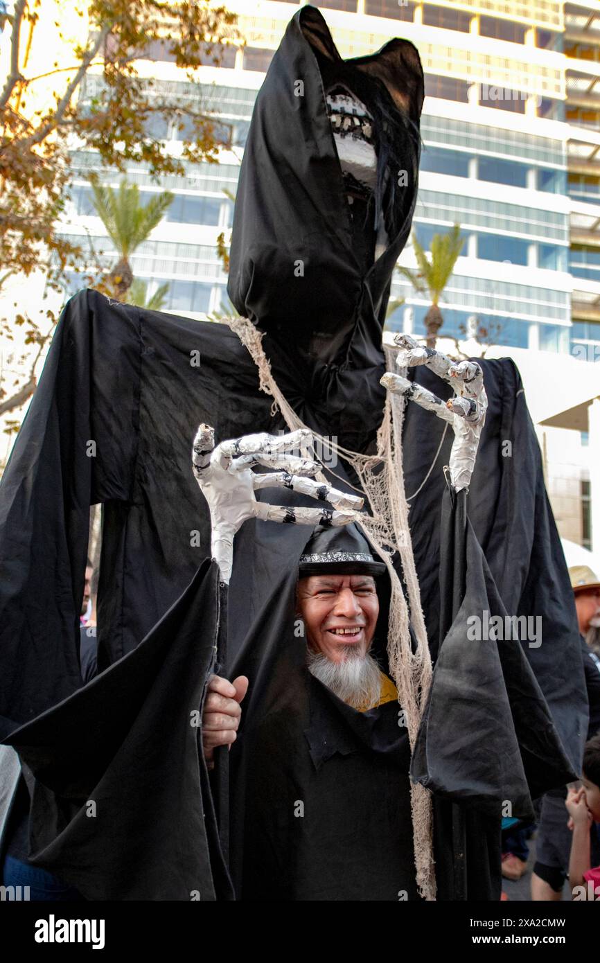 At a Day of the Dead festival in Santa Ana, CA, a man parades in a ...