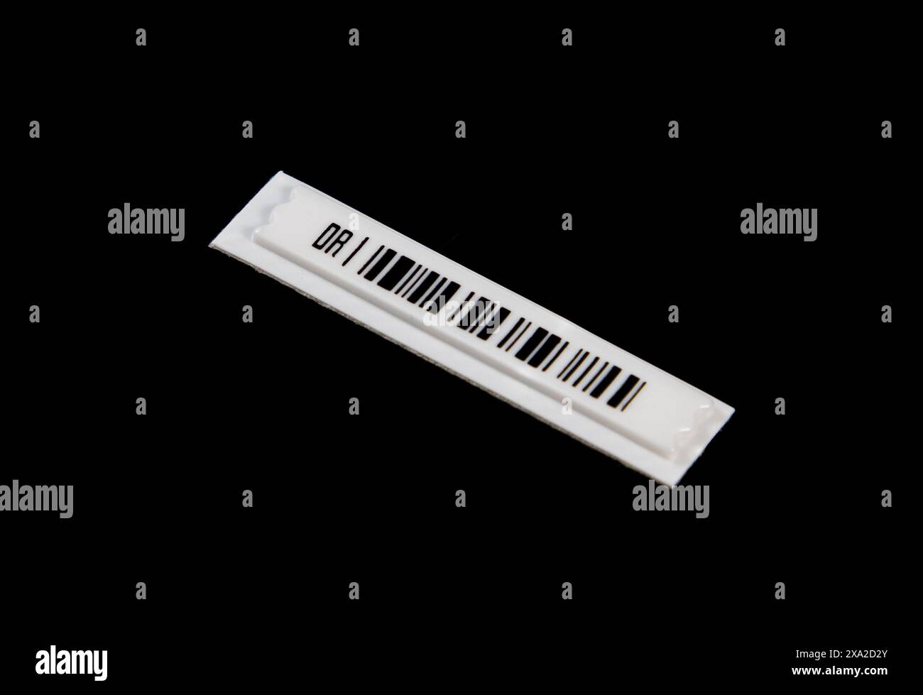 Anti-theft magnetic barcode label on black backdrop Stock Photo - Alamy