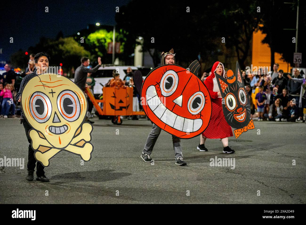 Multiracial participants in a night time Halloween parade in Anaheim ...