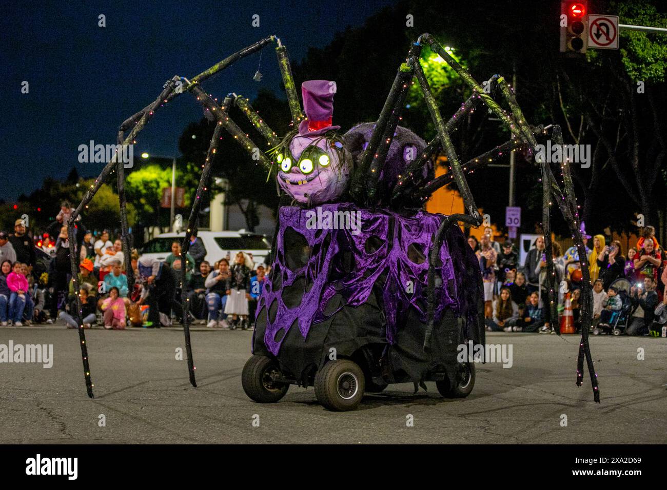A parade float depicting a menacing spider joins a night time Halloween ...