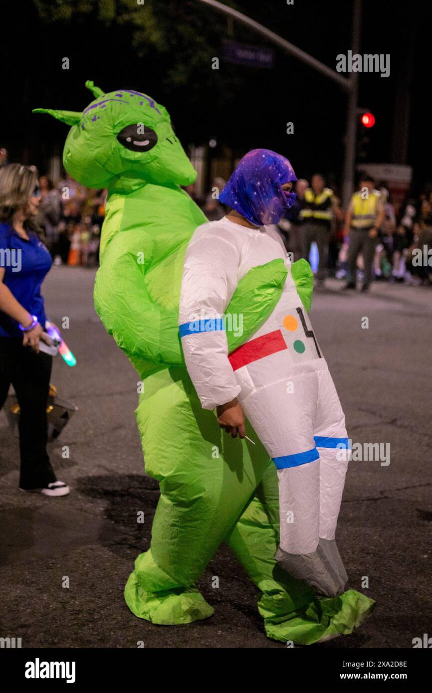 A costumed marcher in a night time Halloween parade in Anaheim, CA ...
