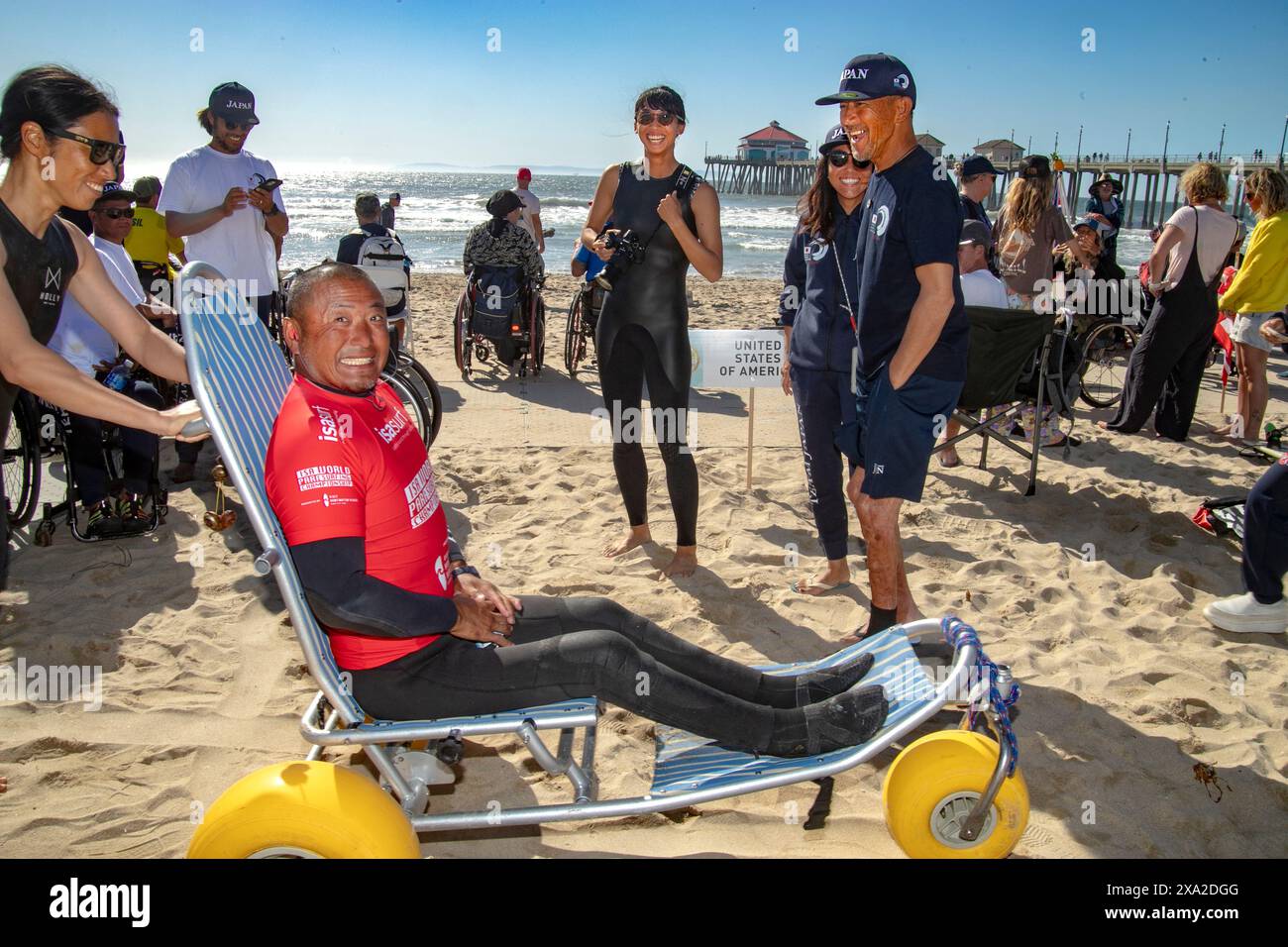 A happy handicapped Asian American parasurfer is transported in a ...