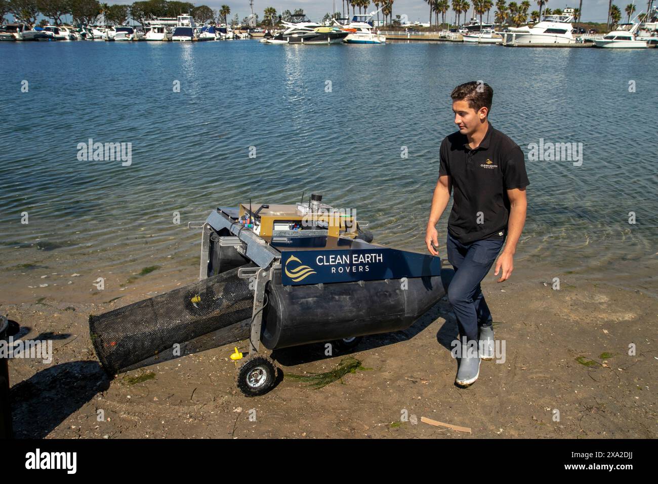 A robot floating trash collector is readied for launching in Huntington ...