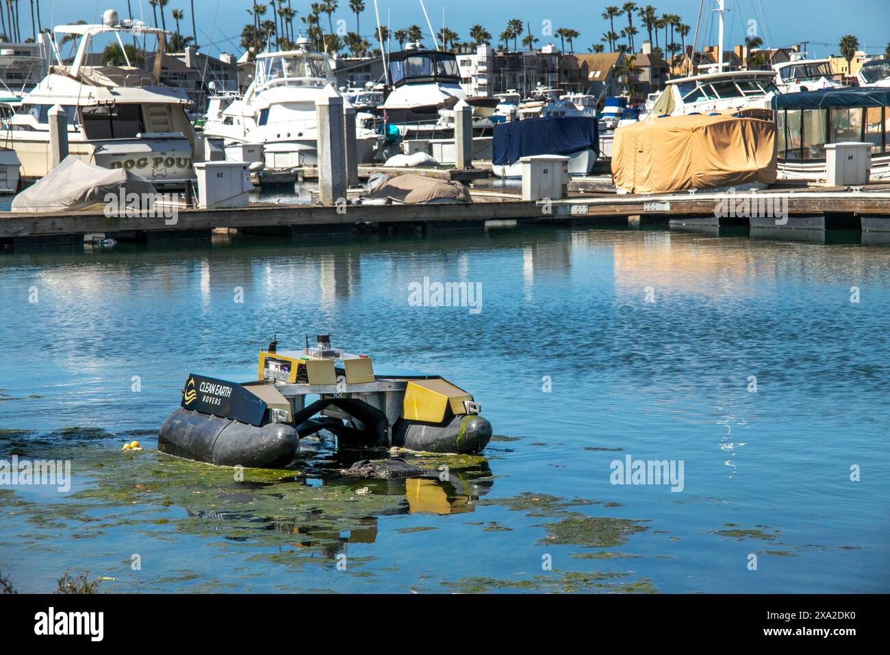 A robot floating trash collector sails in Huntington Beach, CA ...