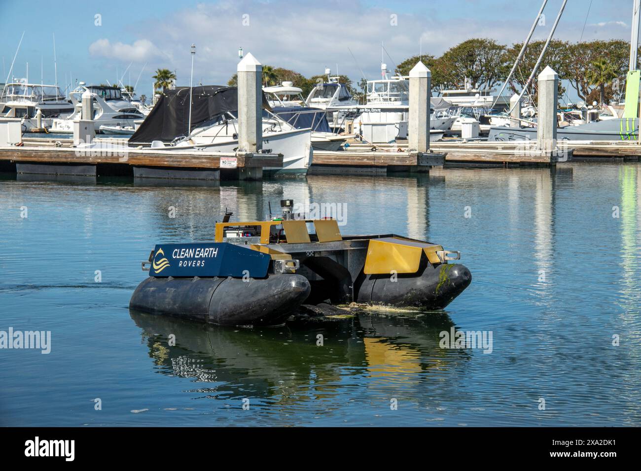 A robot floating trash collector sails in Huntington Beach, CA ...