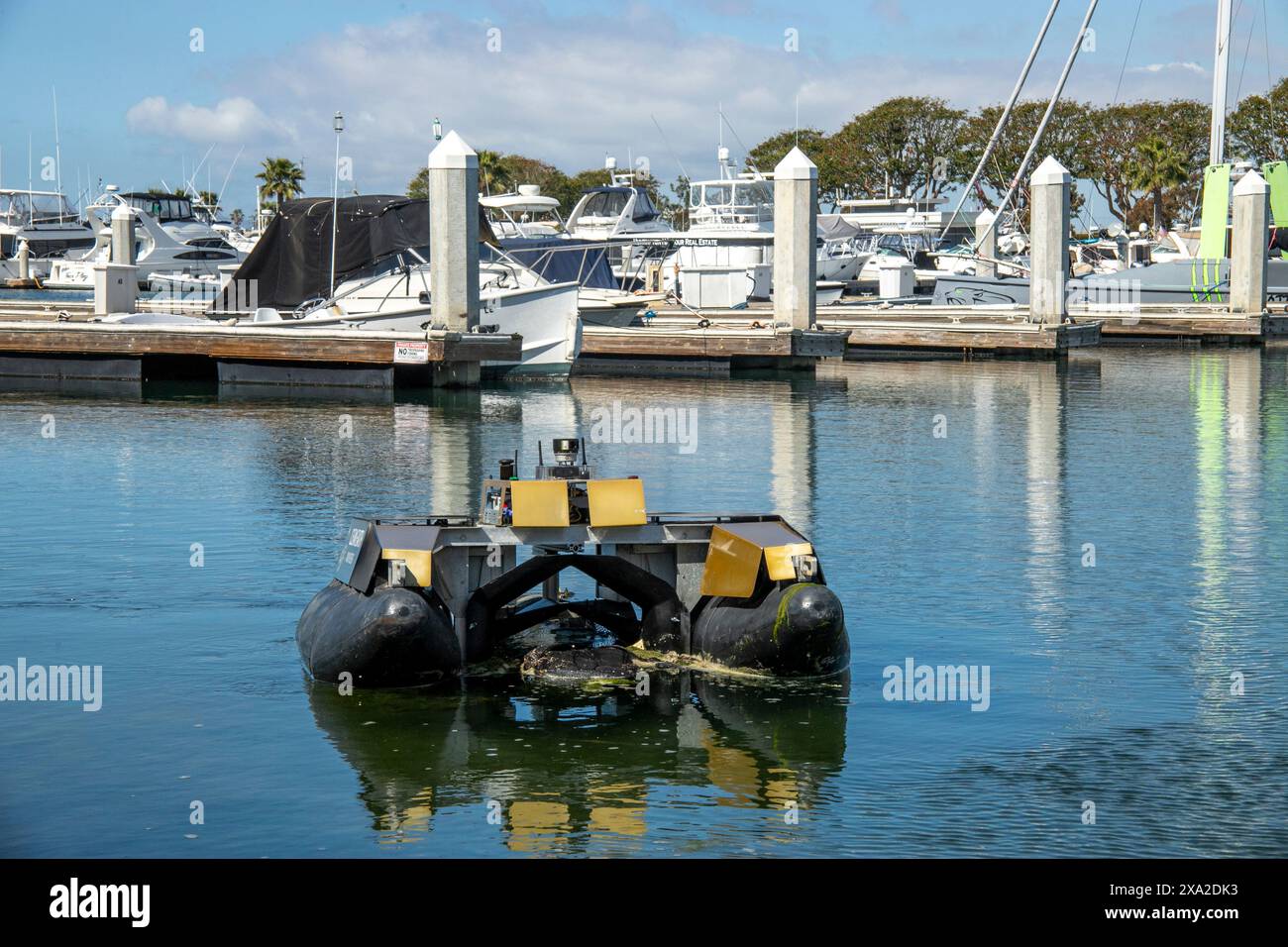 A robot floating trash collector sails in Huntington Beach, CA ...