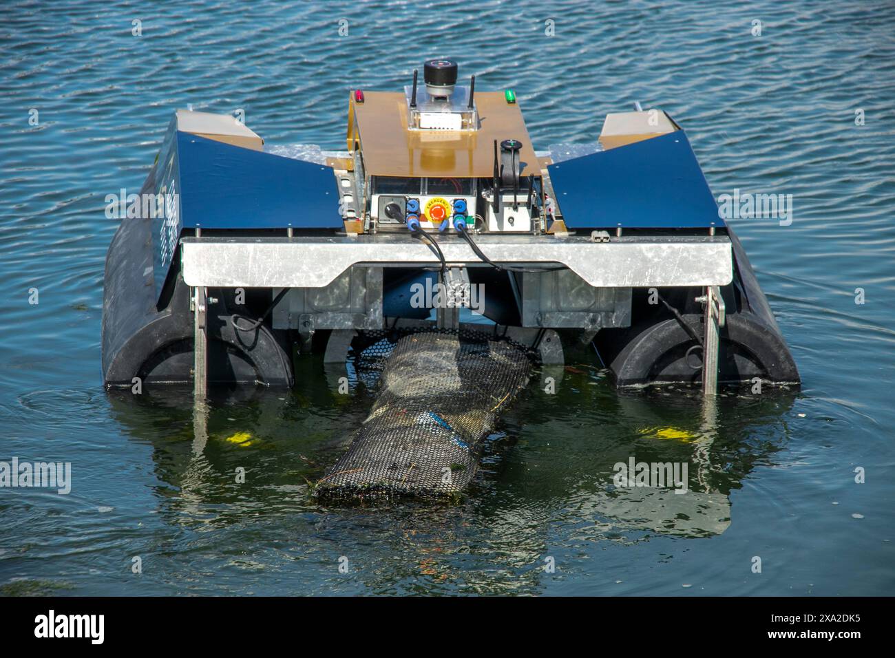 A robot floating trash collector sails in Huntington Beach, CA ...
