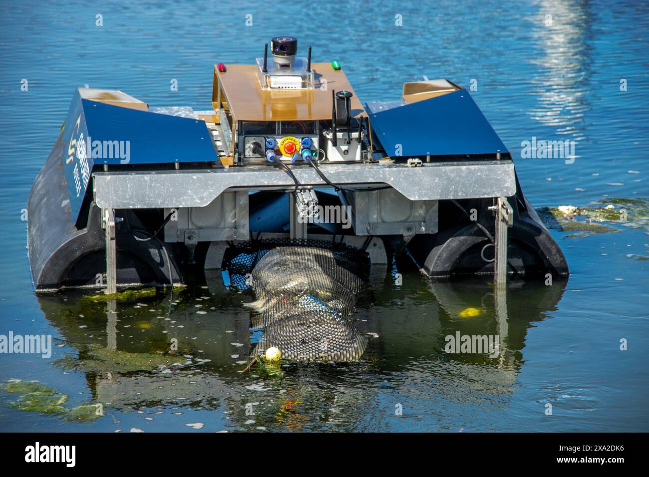 A robot floating trash collector sails in Huntington Beach, CA ...