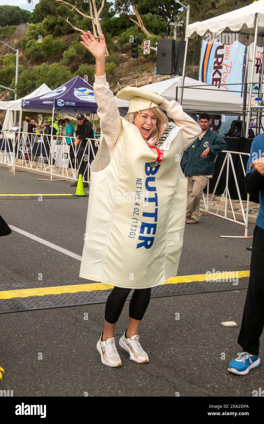 A contestant wearing a butter costume cheers in a costume contest at a ...