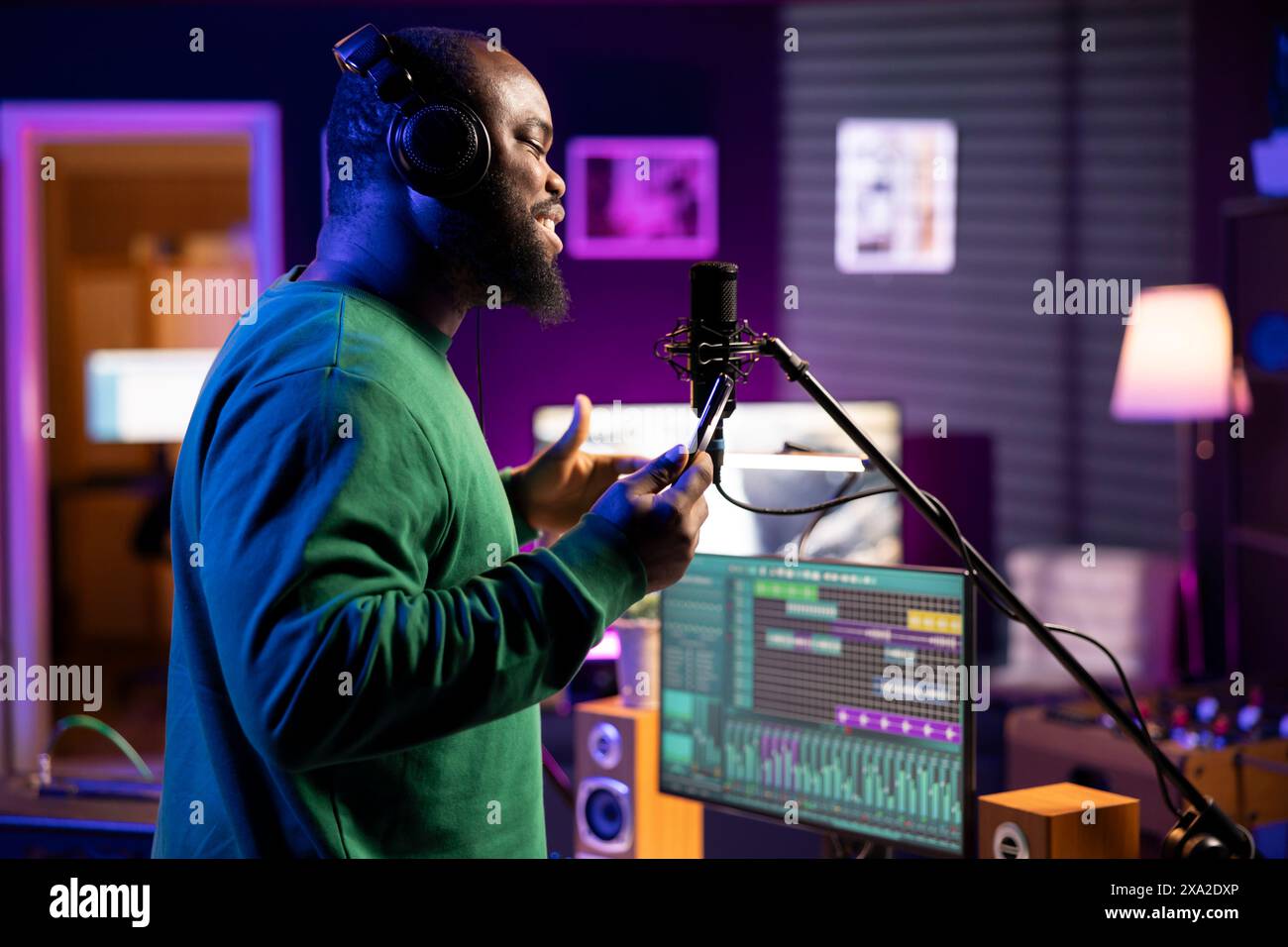 Young performer singer does a recording session for his acoustic song ...