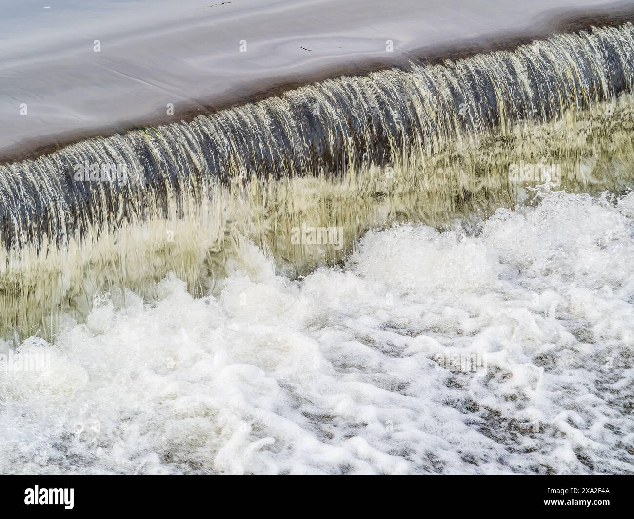 A small flat cascade in a calm river. Water background Stock Photo - Alamy
