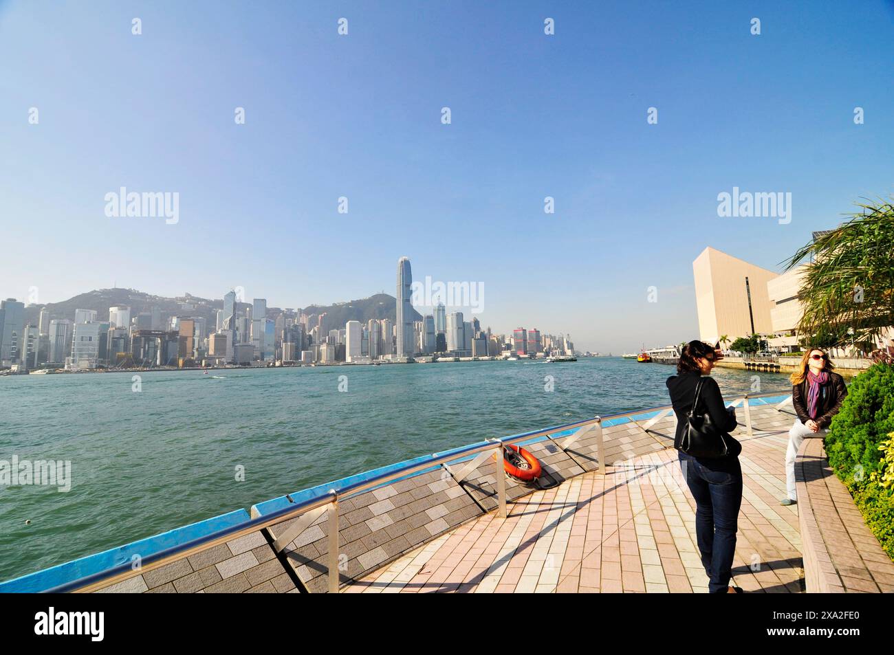 Tourist enjoying themselves on the waterfront promenade in TST, Kowloon ...