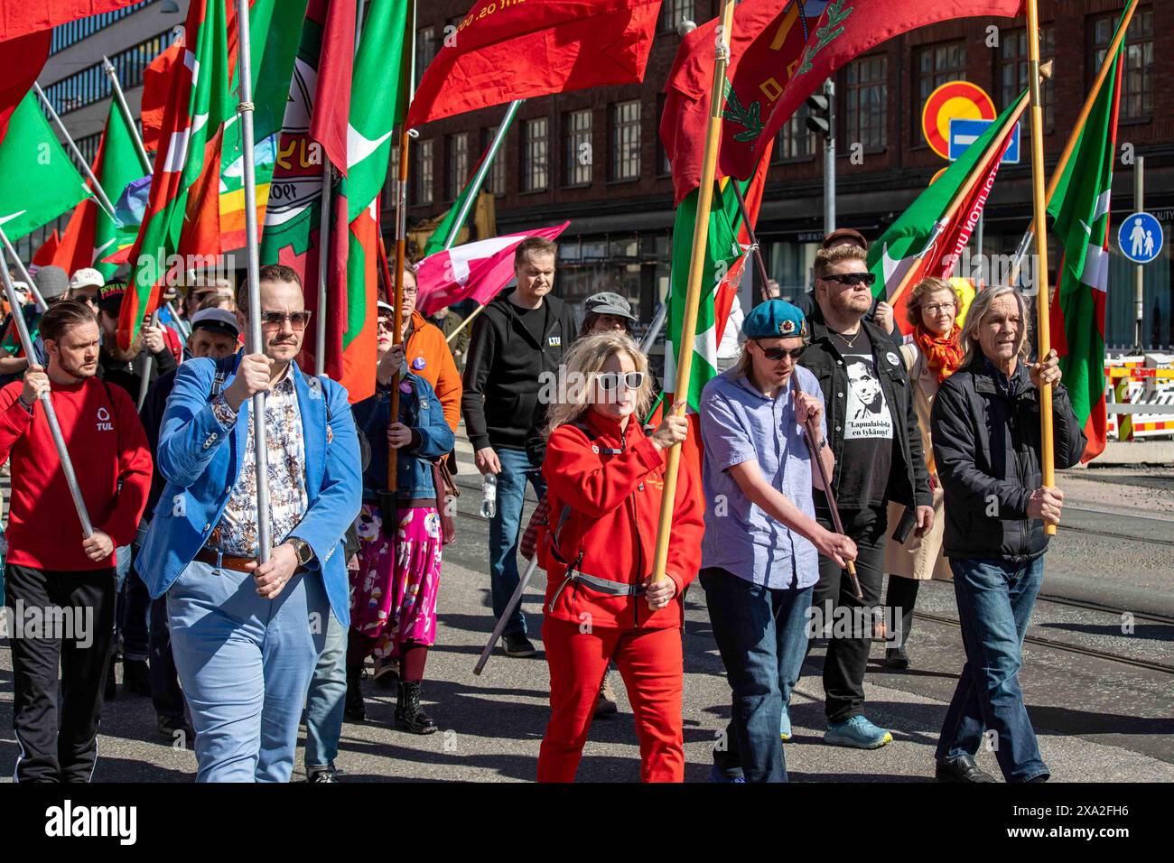 People carrying political flags at Labor Day march on Siltasaarenkatu ...
