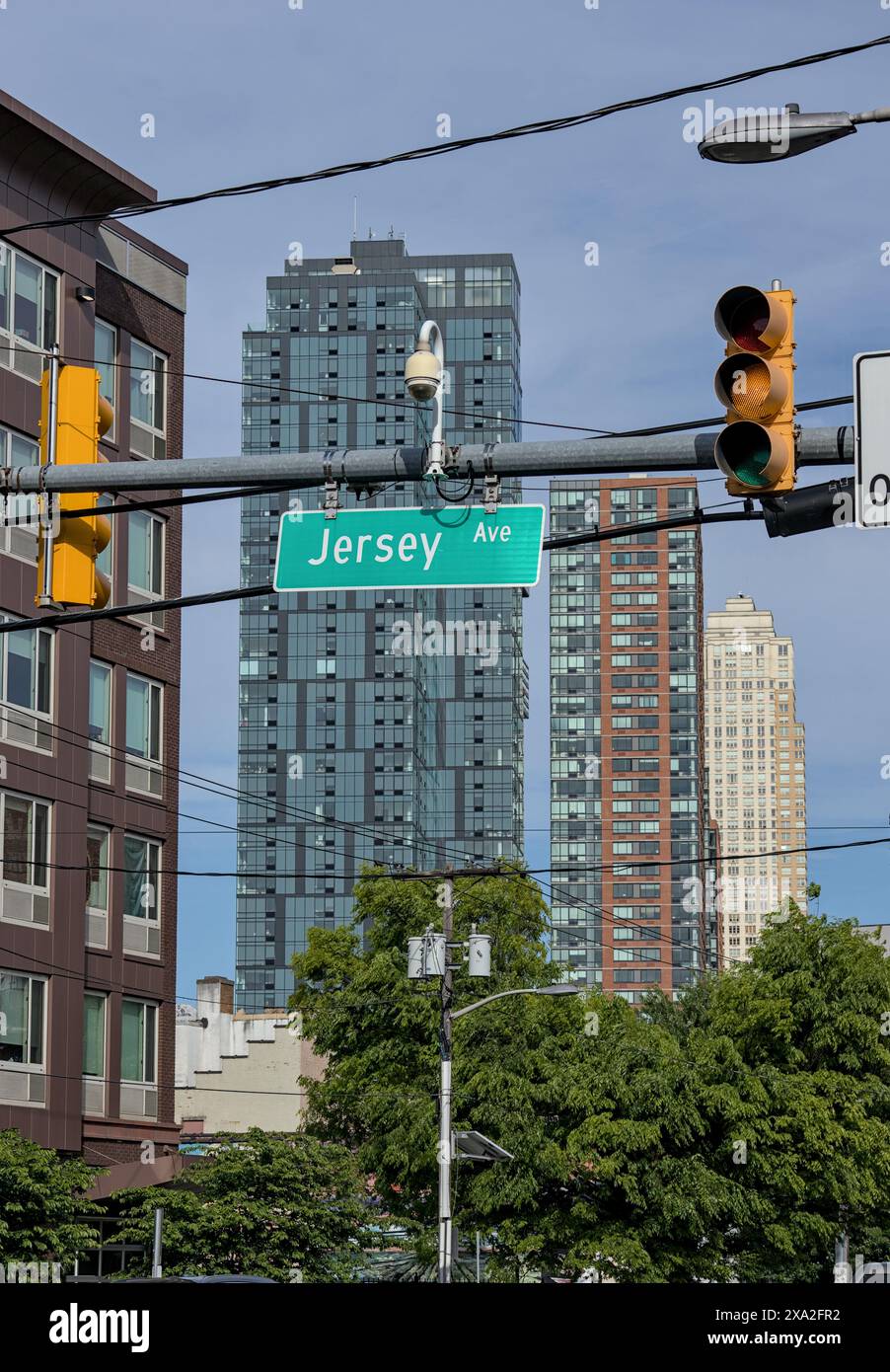jersey avenue street sign on traffic intersection with tall modern ...