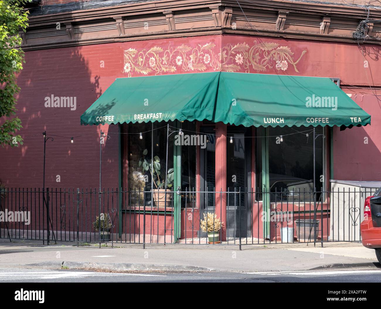 Small cafe with awning sign saying breakfast lunch coffee tea in a red ...