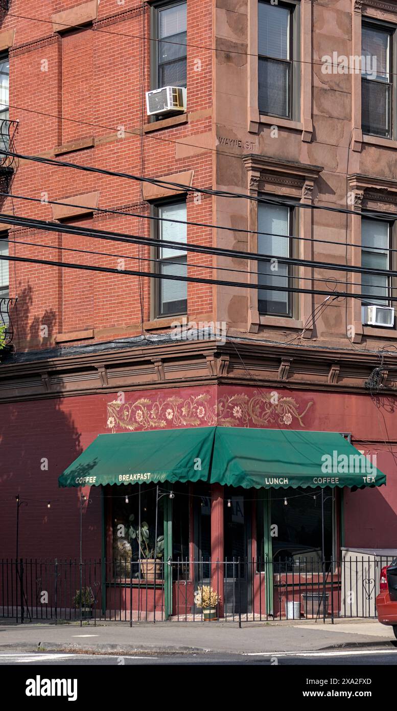 Small cafe with awning sign saying breakfast lunch coffee tea in a red ...