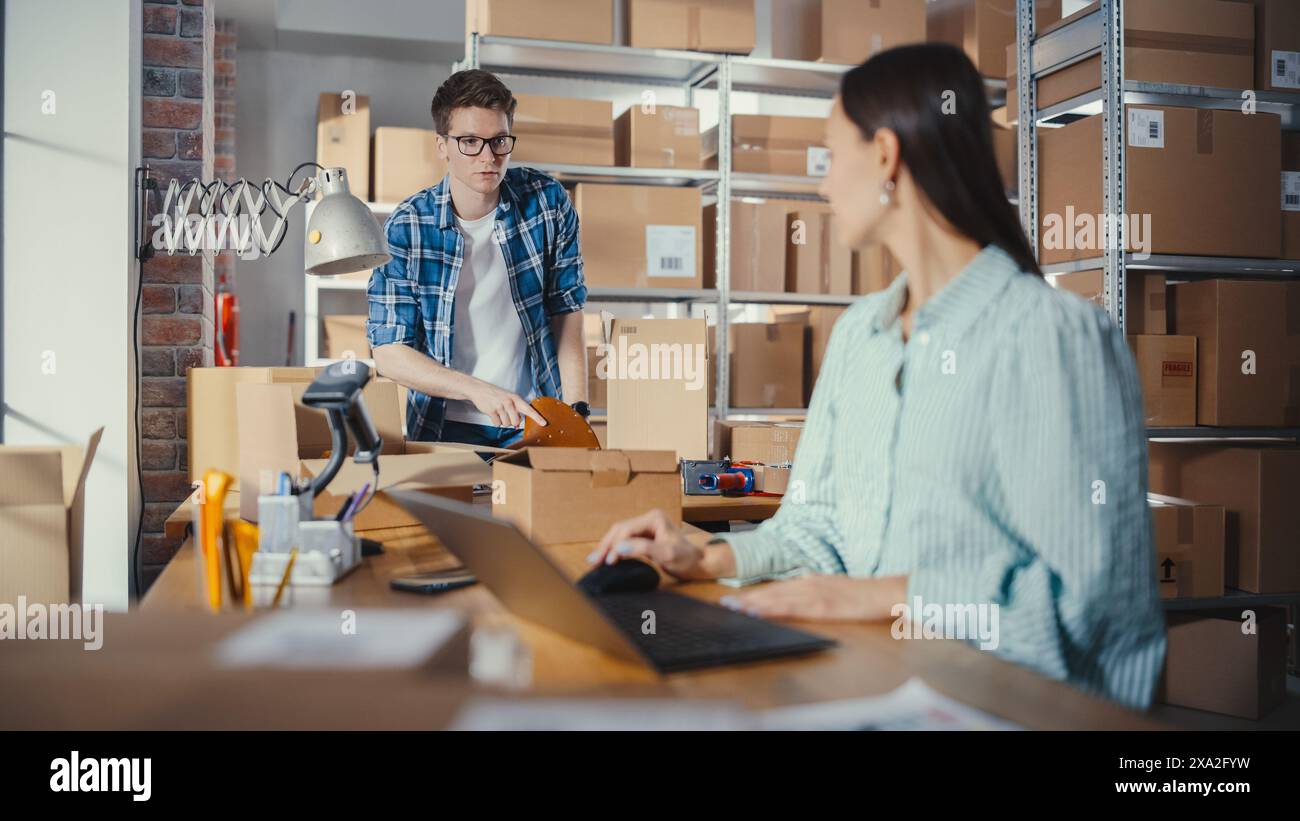 Young Male and Female Warehouse Inventory Managers Packing Orders for ...