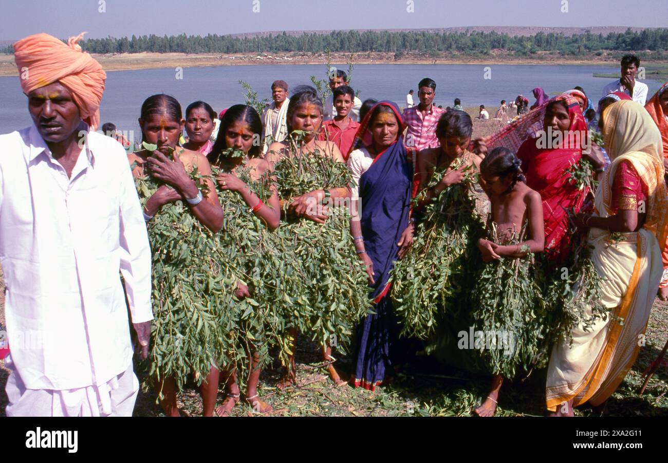 India: Devotees of the goddess Yellamma covered with neem leaves ...