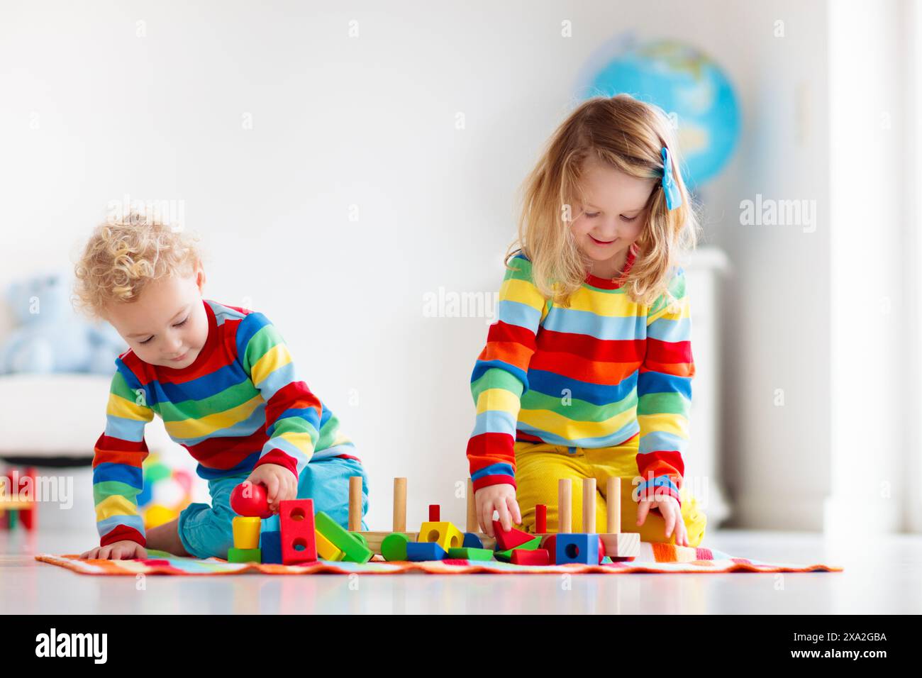 Children playing with wooden train. Toddler kid and baby play with ...