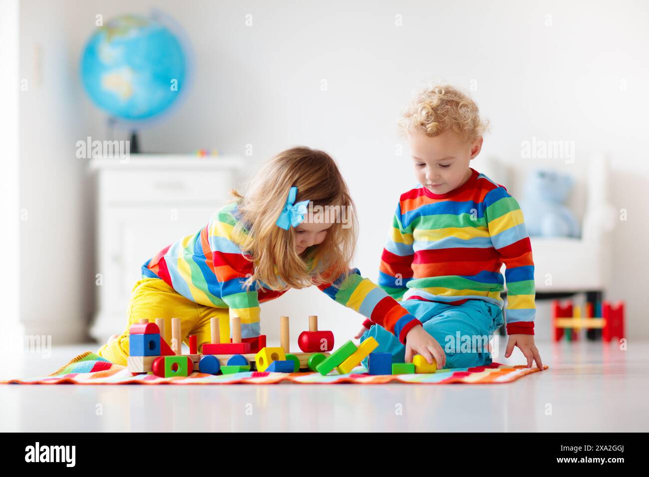 Children playing with wooden train. Toddler kid and baby play with ...