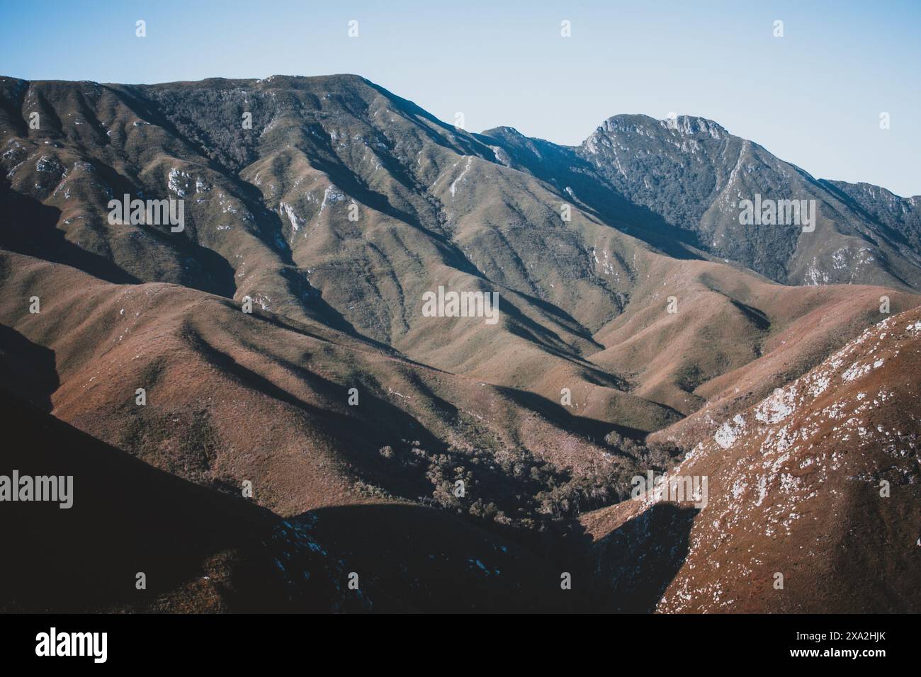 This breathtaking photograph captures the rolling, rugged terrain of a ...