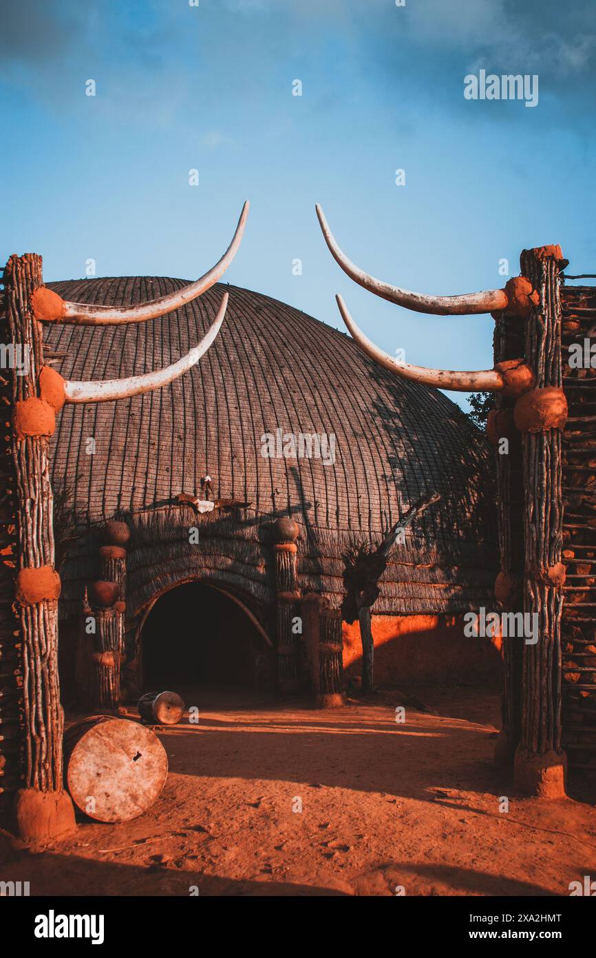 This stunning photograph captures a tribal hut with dramatic African ...
