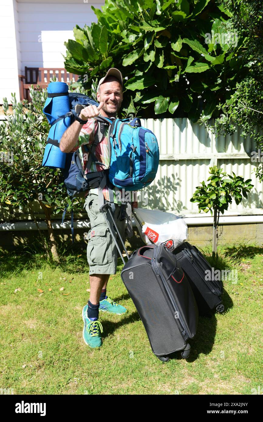 A traveler carrying his luggage Stock Photo - Alamy
