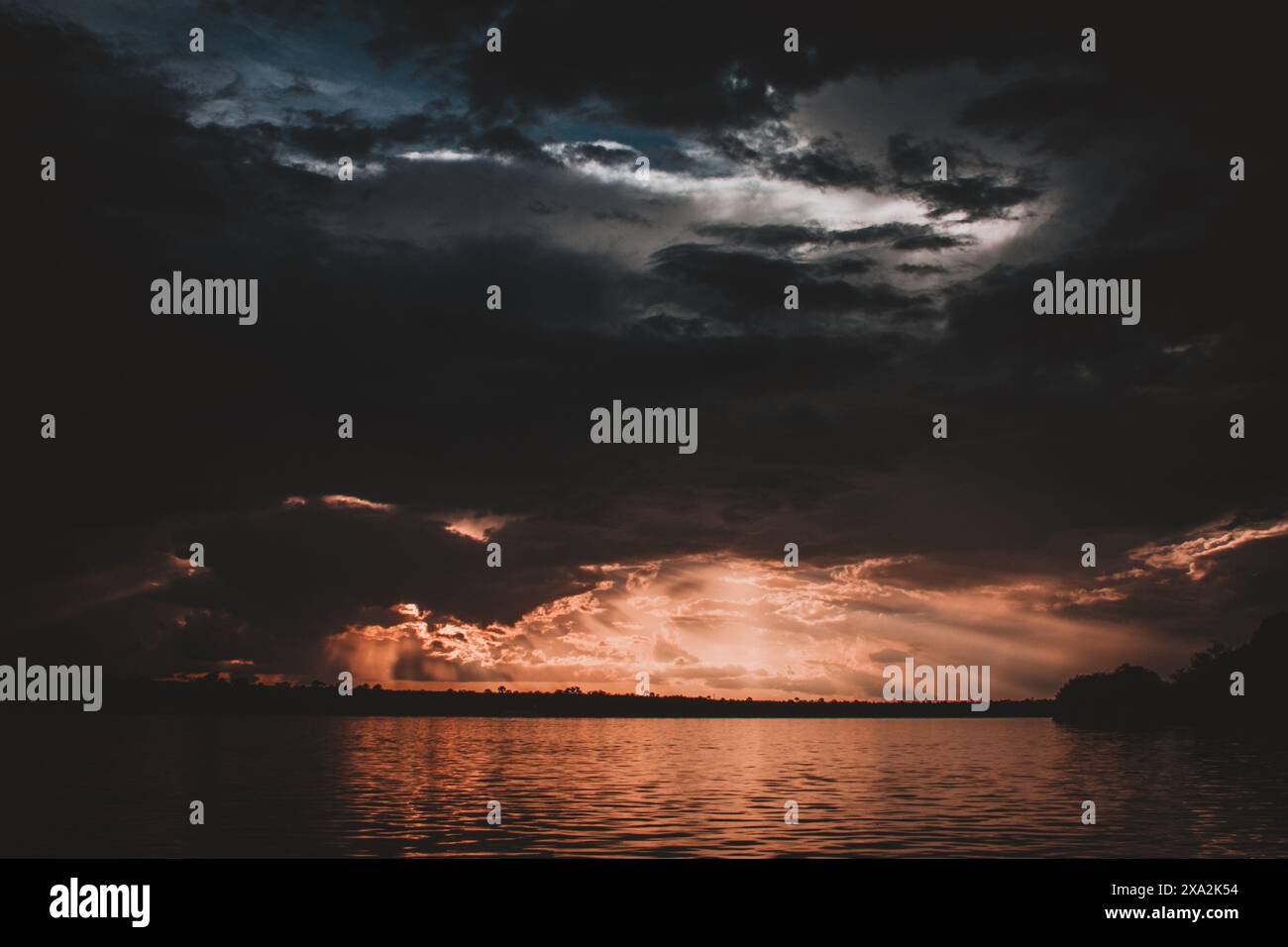 A stunning image capturing the dramatic sunset over the Zambezi River ...