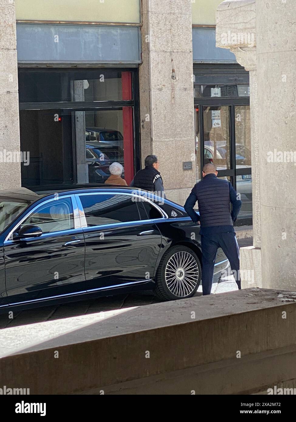 Cremona, Italy - May 2nd 2024 Driver in a suit and a security guard are ...