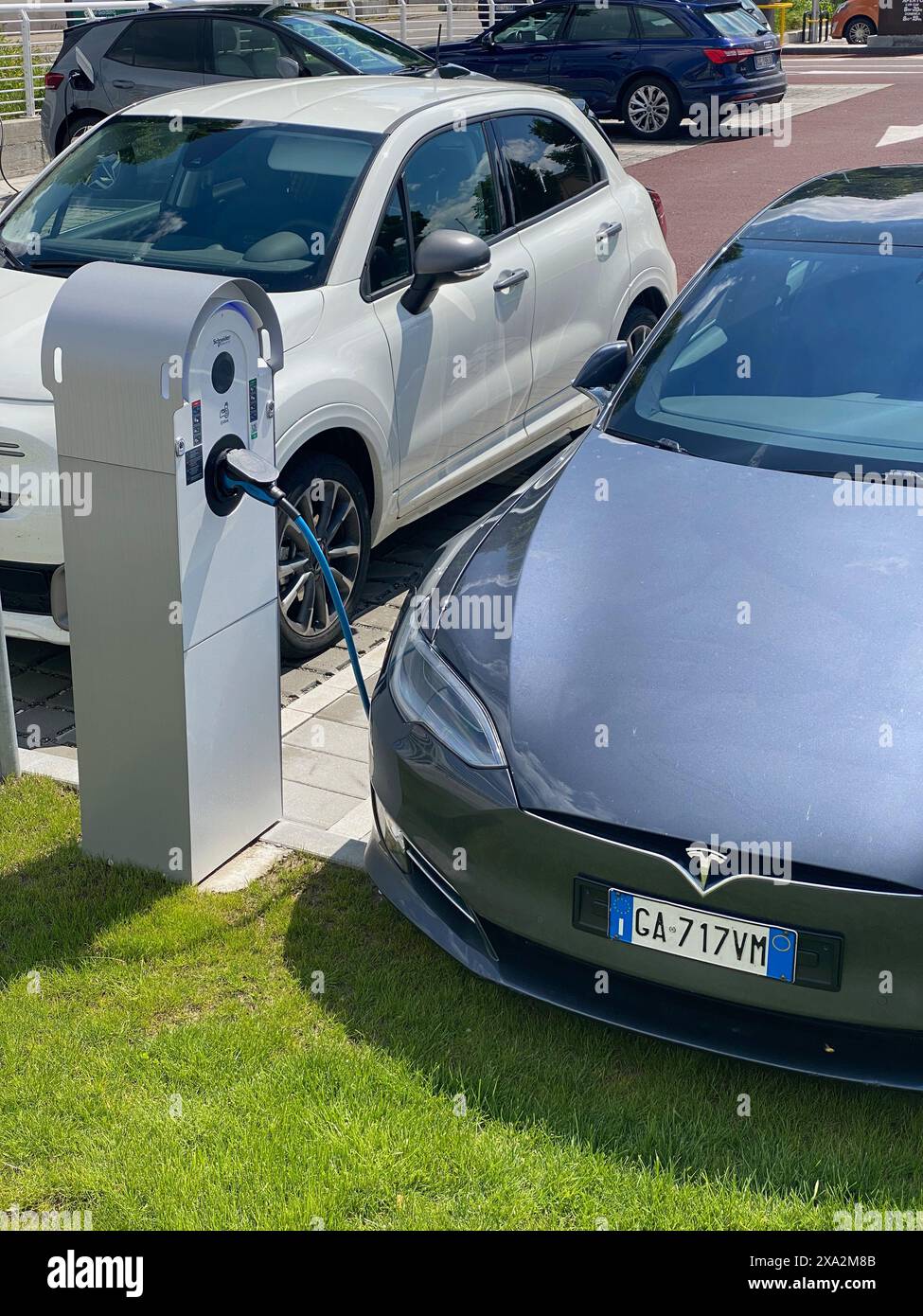 Cremona, Italy - May 2nd 2024 Two electric cars, a tesla and a fiat ...