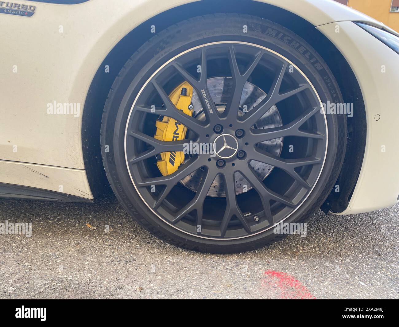 Cremona, Italy - May 2nd 2024 AMG 63 Mercedes Benz Sleek sports car wheel with yellow brake ...