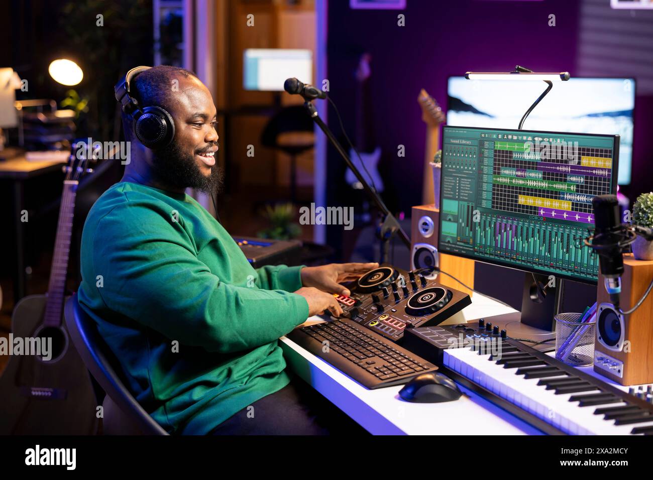 Young musician twisting knobs mixing hi-res stock photography and ...