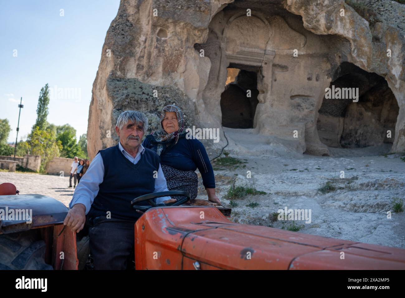 A couple poses on their tractor in front of the historical building on ...