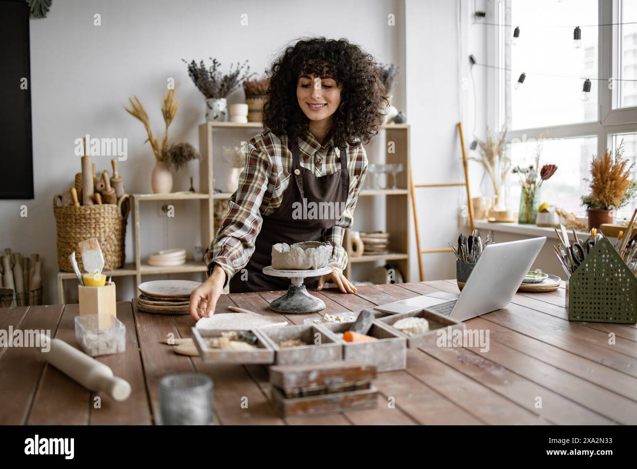 Female artisan working with clay in art studio Stock Photo - Alamy