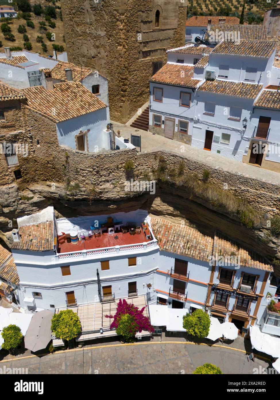 Close-up of houses integrated between rock walls with a terrace and ...